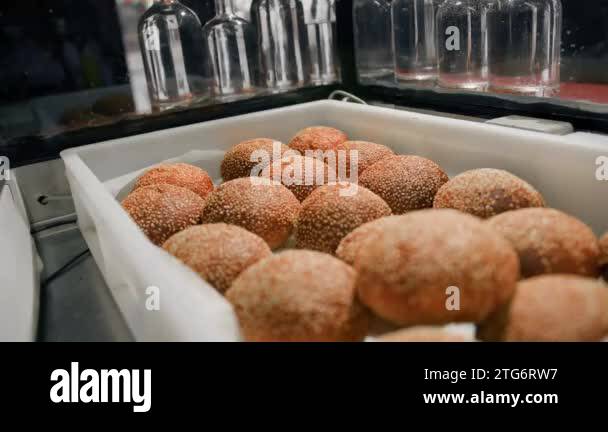 Burger buns are stacked in a food container in restaurant kitchen Stock ...