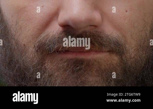 Authentic macro shot of young man showing candid smile in front of ...