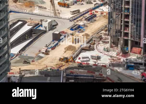 Cranes, excavators and bulldozers working at construction site of new ...