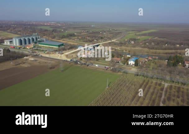 Above view, dolly move, over building site, roundabout and road goes ... Above view, dolly move, over building site, roundabout and road goes ...