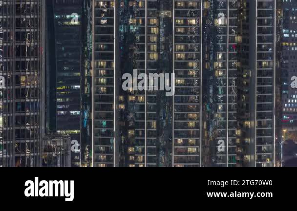 Windows lights in modern tower buildings timelapse at night. Multi ...