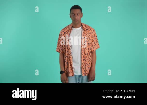 Sleepy dark-skinned guy posing on camera isolated against studio ...