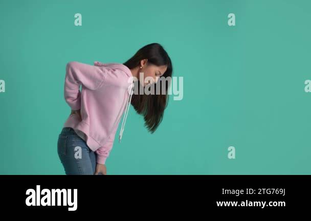 Unhealthy young woman touching injured sore back, suffering from back ...