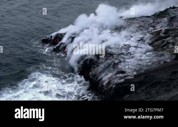 Lava running into pacific ocean and and making a new land. Red hot ...