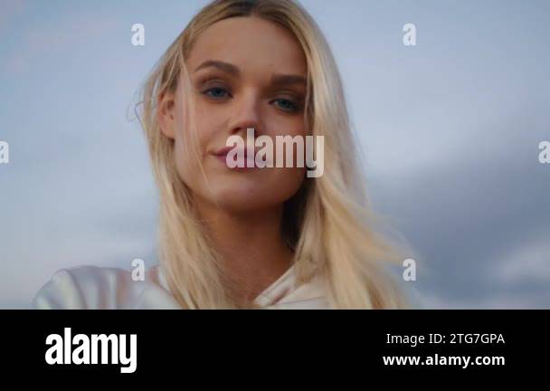 Blonde model posing sunset sky background portrait. Smiling girl face ...