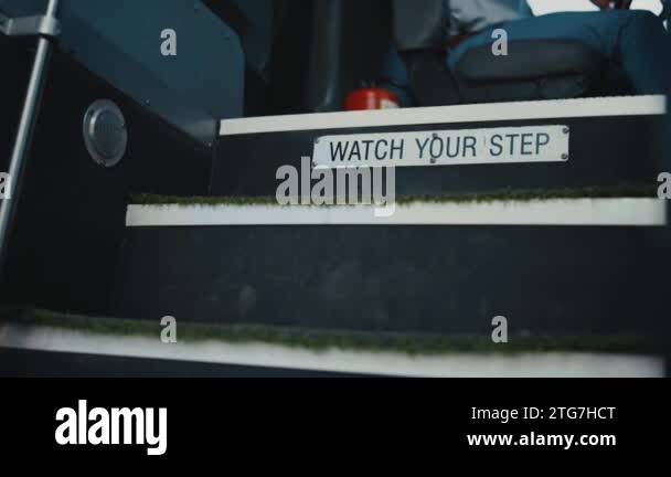 Closeup schoolbus entrance stairs with plate. Sign at open shuttle door ...