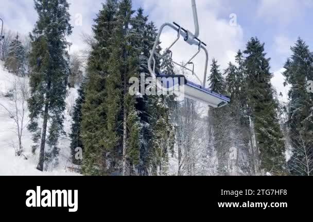POV Empty Ski Lift snowy mountain winter forest with chair lift At The ...