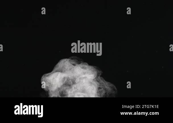 White cloud of vapor from small particles of water rises and floats on ...