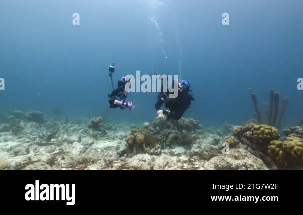 Professional diver, undersea cinematographer filming a self-portrait in ...
