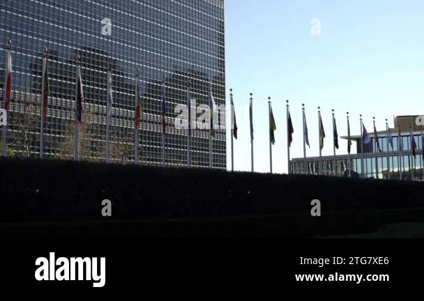 Multiple flags in front of the United Nations headquarters in New York ...