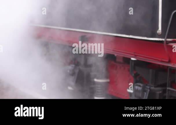 Smoke covering the train. Retro steam locomotive departs from the ...