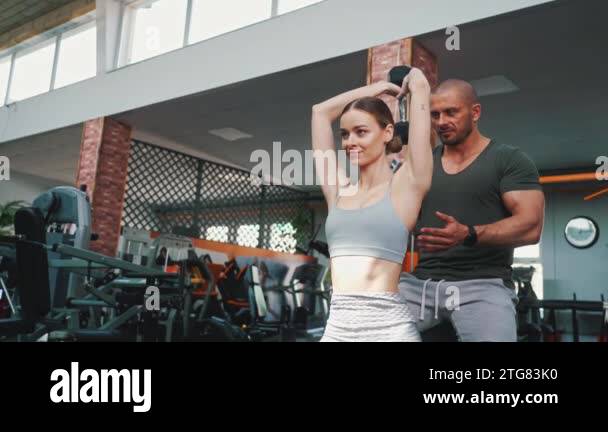 Beautiful dark-haired slim woman in her 20s sitting on a bench and ...