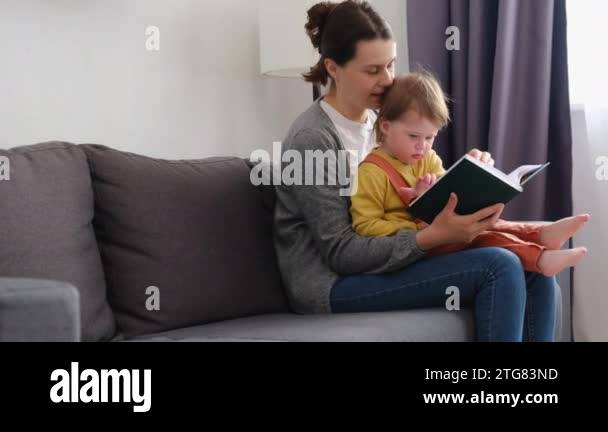 Caring young mother babysitter hug happy cute little kid daughter hold ...