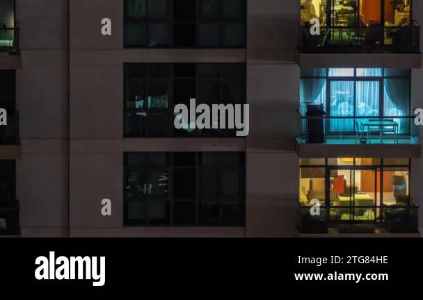 Windows of apartment building at night timelapse, the light from ...