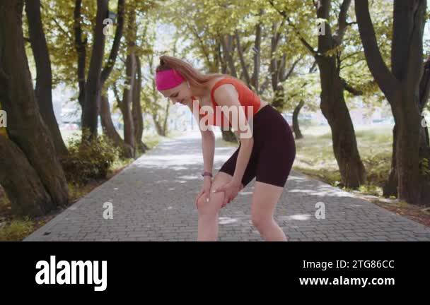 Athletic fit runner girl with muscle pain. Young woman massaging ...
