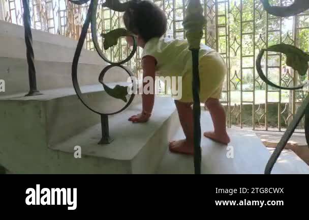 Baby climbing stairs. Cute toddler boy is climbing the stairways at ...