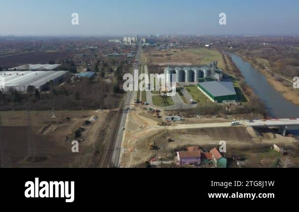 Above view, dolly move, over building site, roundabout and road goes ... Above view, dolly move, over building site, roundabout and road goes ...