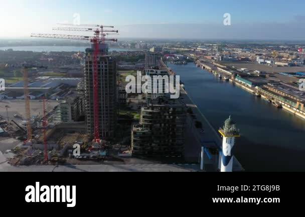 Drone flight over Belgian port city Oostende with harbor and beach in ...
