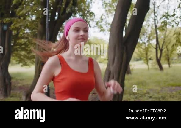 Athletic fitness sport runner girl training marathon run, listening ...