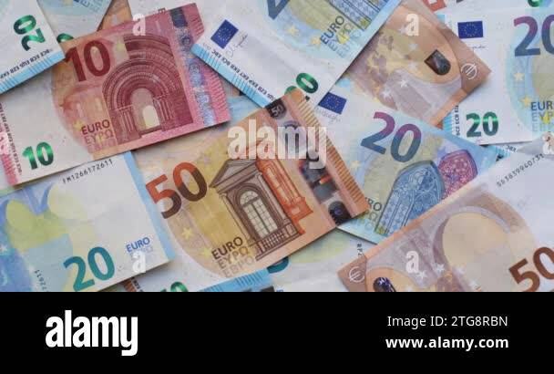 Euro banknotes in various denominations. Pile of banknotes on the table ...