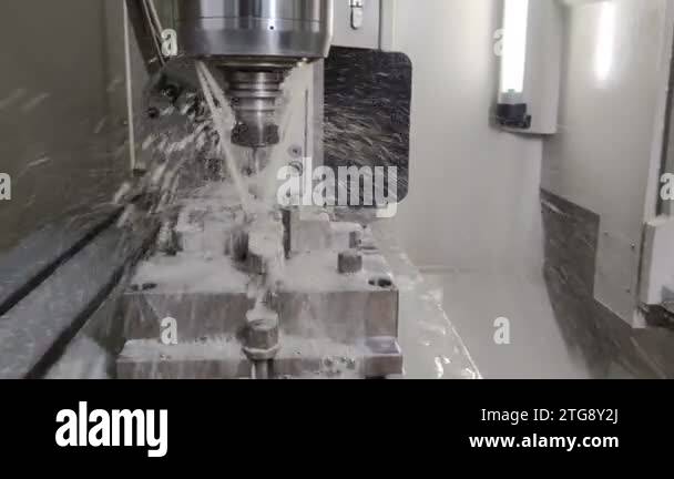 modern cnc 4-axis wet milling process with automatic tool change and coolant streams Stock Video ...