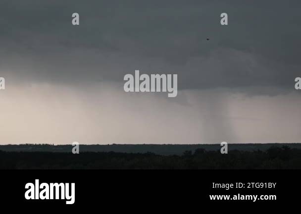 Lightning flash in storm clouds. Heavy clouds bring multiple flashes of ...