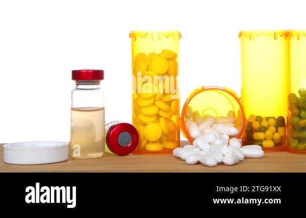 HD video panning across medication bottles standing and spilling on a ...