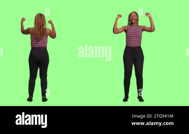 Smiling lovely girl being optimistic over green screen backdrop, full ...