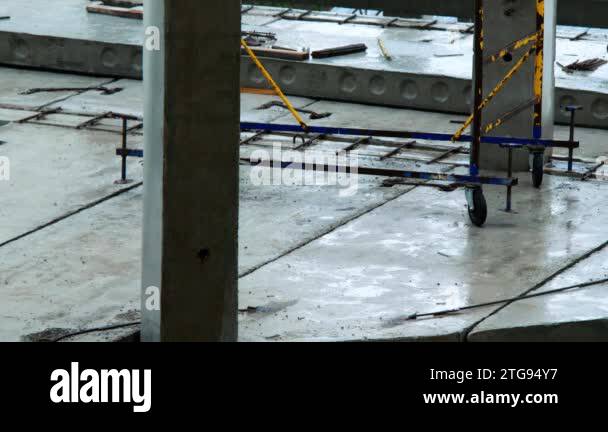 Construction site on the rain. Foundation, floors, concrete piers and ...