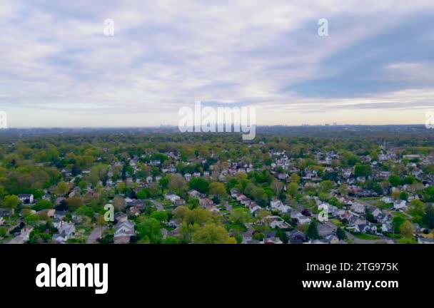 An aerial view of green trees, and houses of Manhattan city in daylight ...