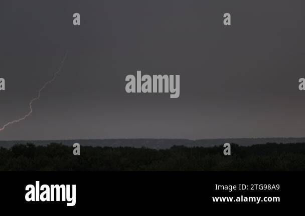Lightning flash in storm clouds. Heavy clouds bring multiple flashes of ...