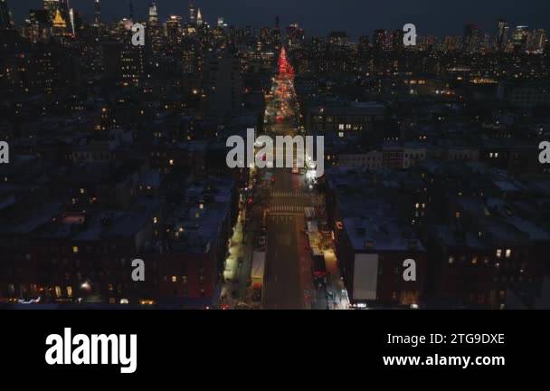 Backwards fly above long straight street in city. Revealing skyline ...