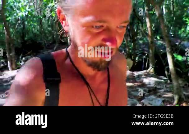 Traveler and tourist guide walks of a cave with amazing blue turquoise ...