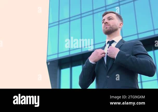 A well dressed happy bearded office corporate male executive standing ...