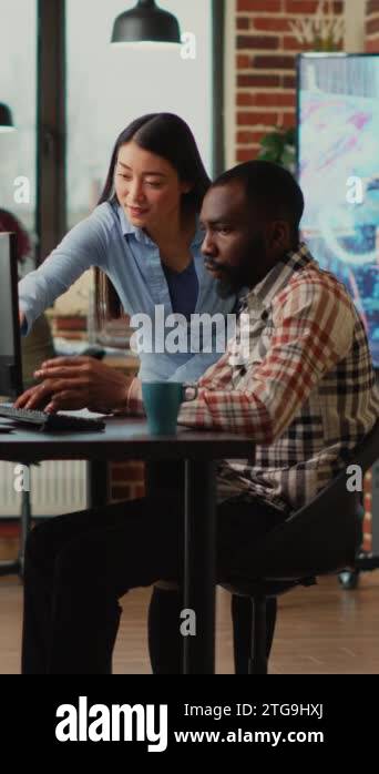 Vertical video: Diverse engineers working on turbine component with ...