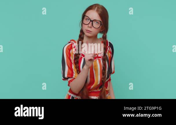 Displeased girl shakes finger and saying no, be careful, scolding and ...