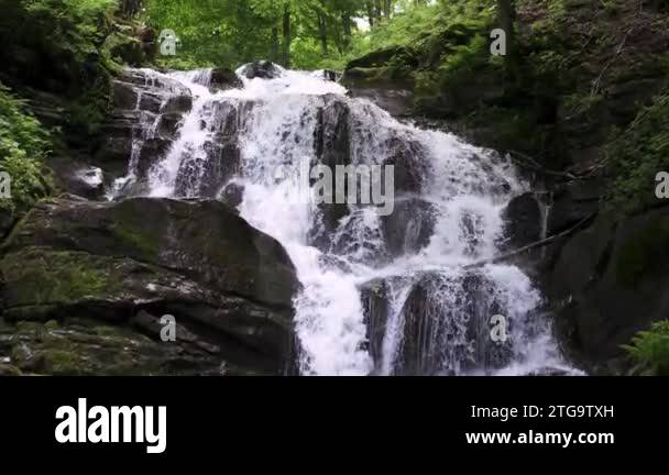 Green waterfall river rocks covered with green moss forest waterfall ...