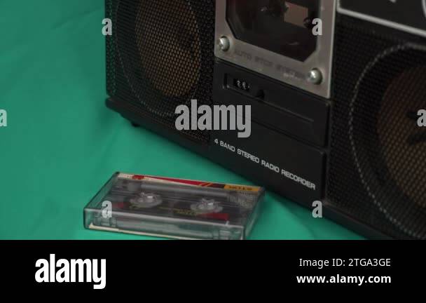 Girl puts vintage cassettes near the black radio tape recorder. Black ...