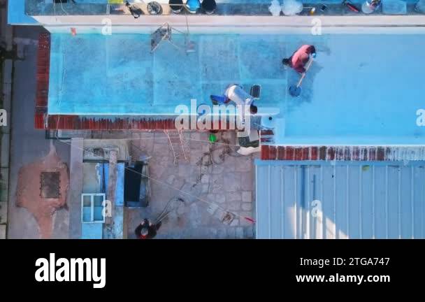 Aerial view with the drone of workers who carry out the waterproofing ...