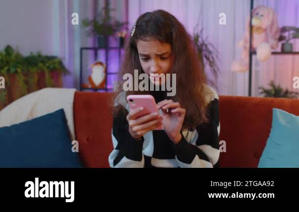 Preteen girl use smartphone typing browsing, loses becoming surprised ...