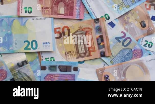 Euro banknotes in various denominations. Pile of banknotes on the table ...