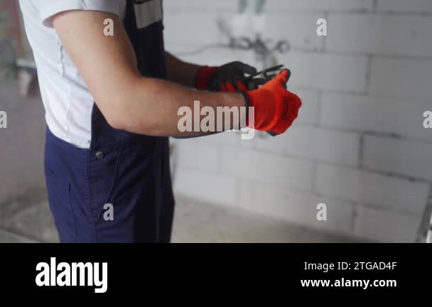 Electrician laying wiring cable, mounting electricity lines in the ...