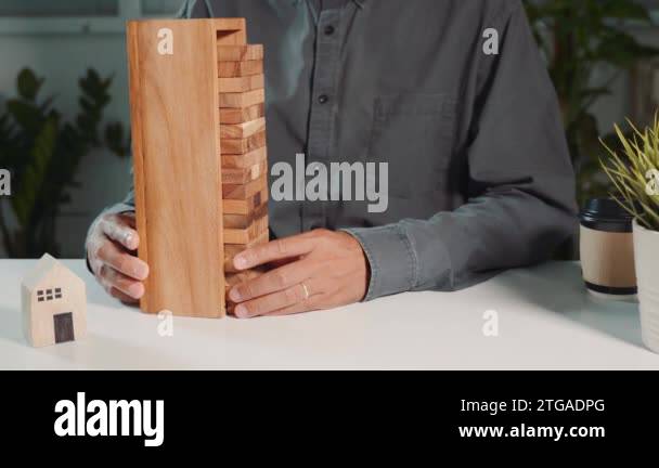 Business pulling box from building tower challenge game. Businessman ...