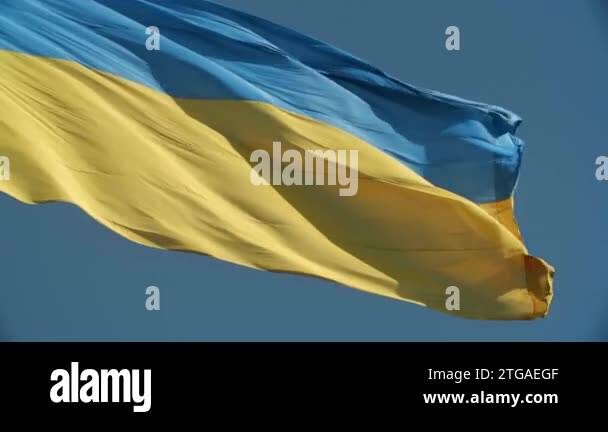 Ukrainian flag as a symbol of independence and unity in blue sunny sky ...