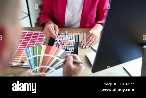 People in the office choose a sample from a color palette, a close-up ...