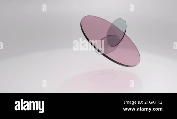 Translucent round glass lenses spinning and rotating on white ...