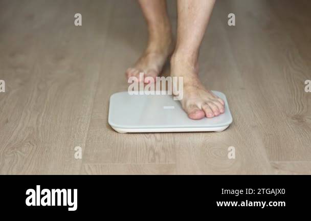 Man walking on scales measure weight. male wal checking BMI weight loss ...