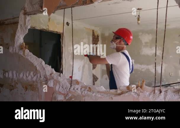 Contractor wrecks wall with sledgehammer making hole for rearrangement ...
