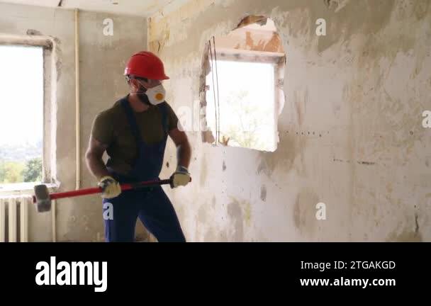 Contractor wrecks wall with sledgehammer making hole for rearrangement ...
