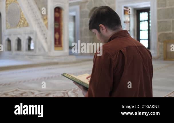 Image taken from the back of the young man reciting the Quran while ...